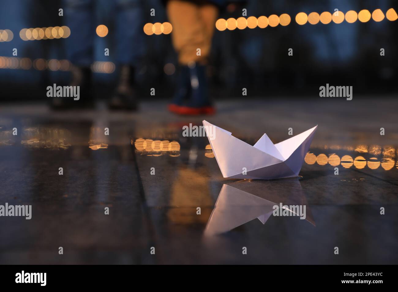 White paper boat in puddle on street Stock Photo - Alamy