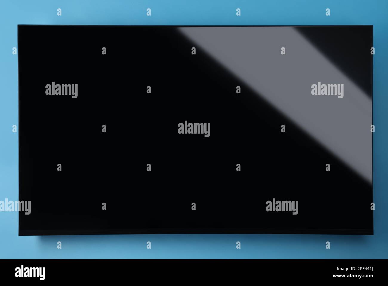 Modern TV with blank wide screen on light blue background Stock Photo ...