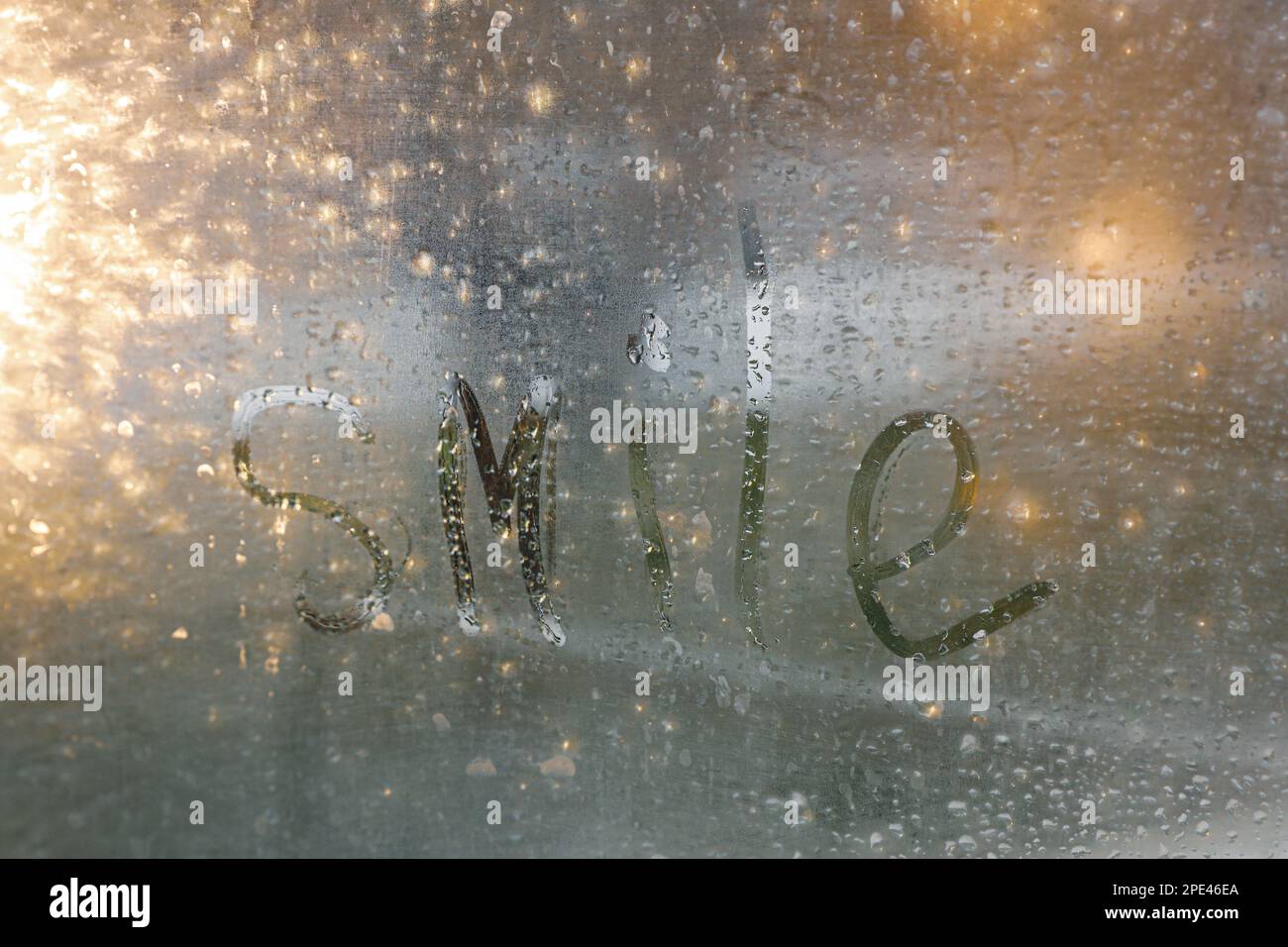 Word Smile written on foggy window. Rainy weather Stock Photo - Alamy