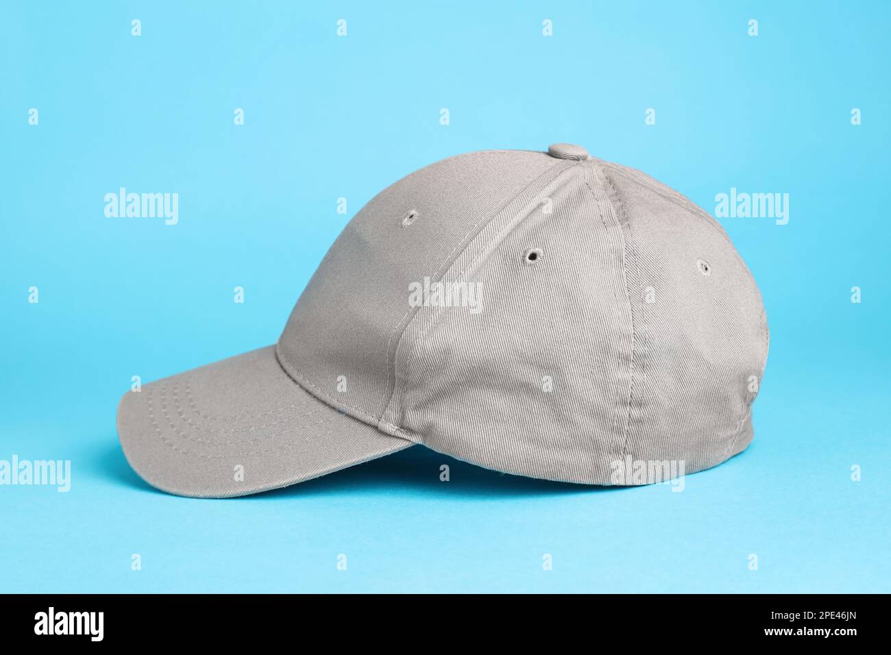 Stylish grey baseball cap on light blue background Stock Photo - Alamy