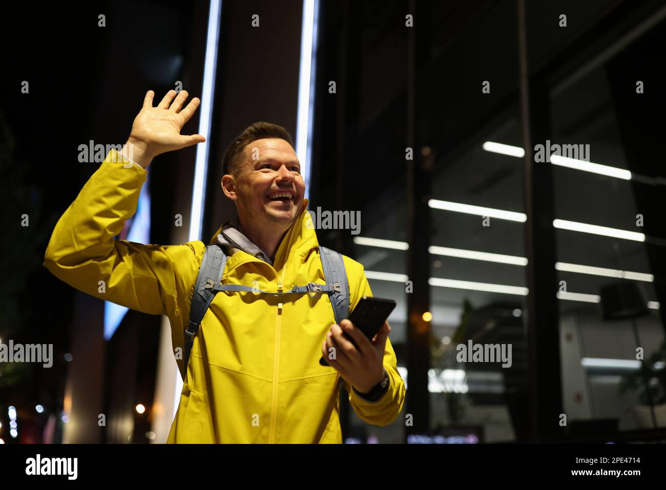 Happy smiling tourist holding smartphone and welcoming people in the ...