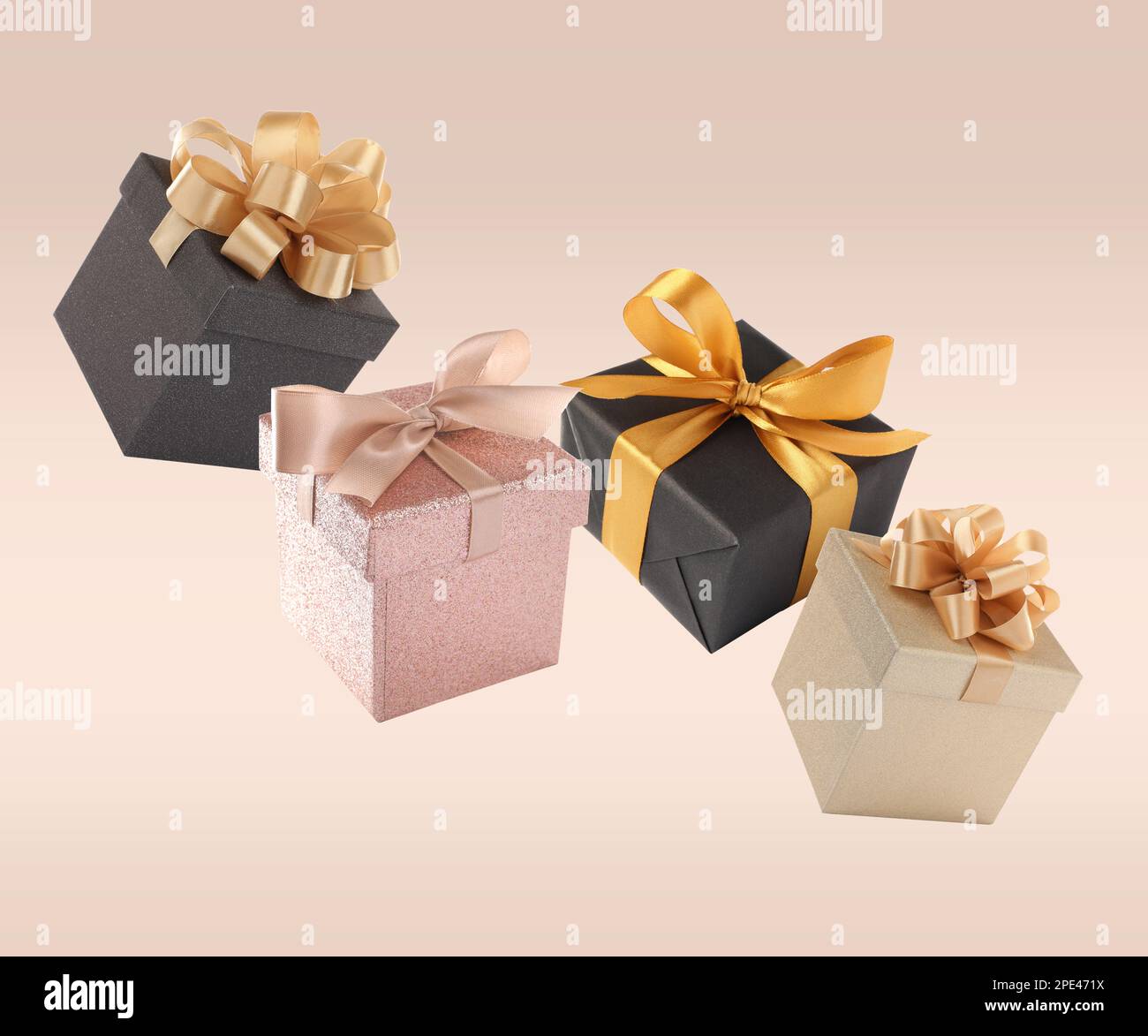 Beautifully wrapped gift boxes flying on beige background Stock Photo ...