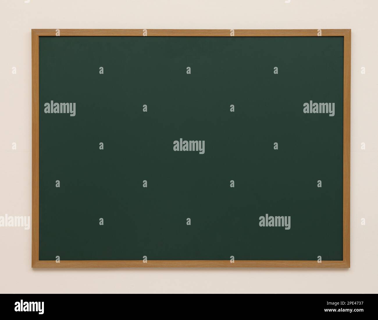 Clean green chalkboard hanging on white wall Stock Photo - Alamy