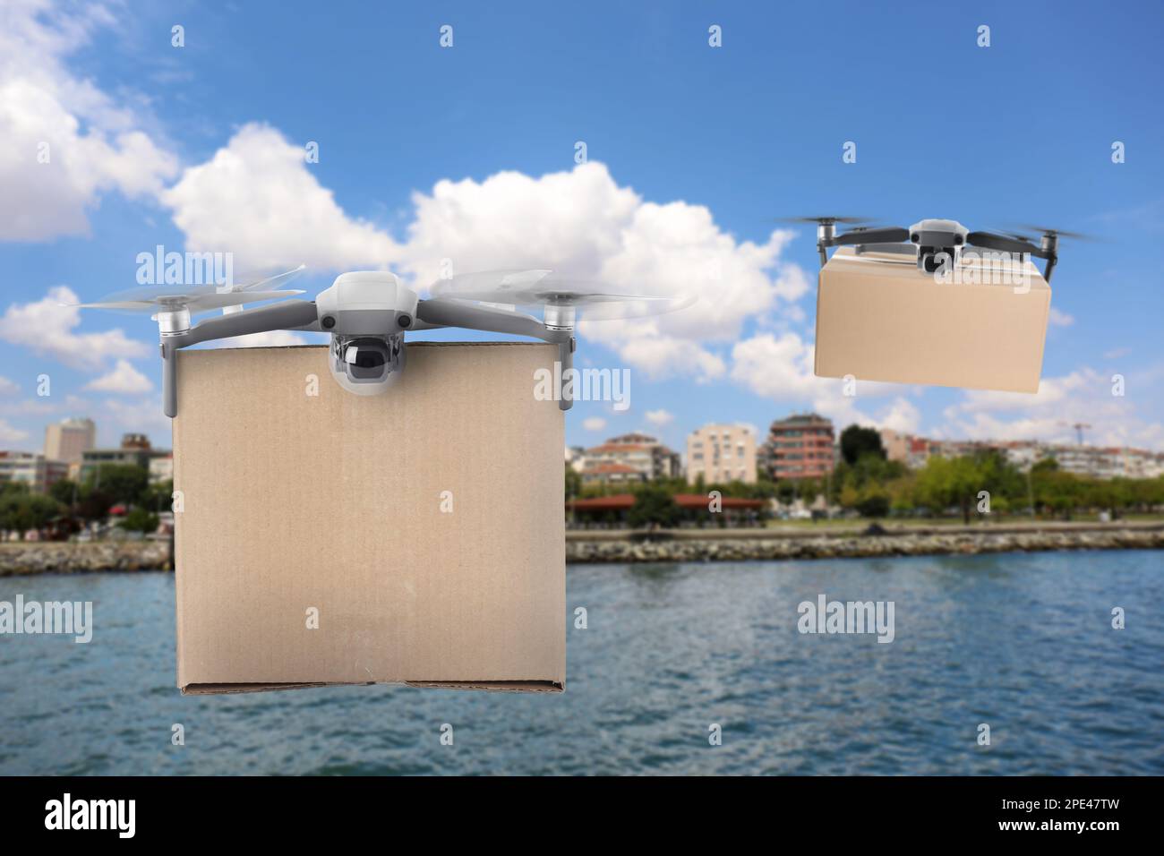 Modern drones with carton boxes flying above sea on sunny day. Delivery ...