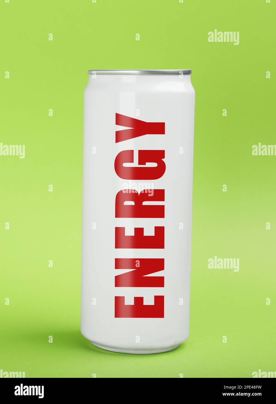 Can of energy drink on light green background Stock Photo - Alamy