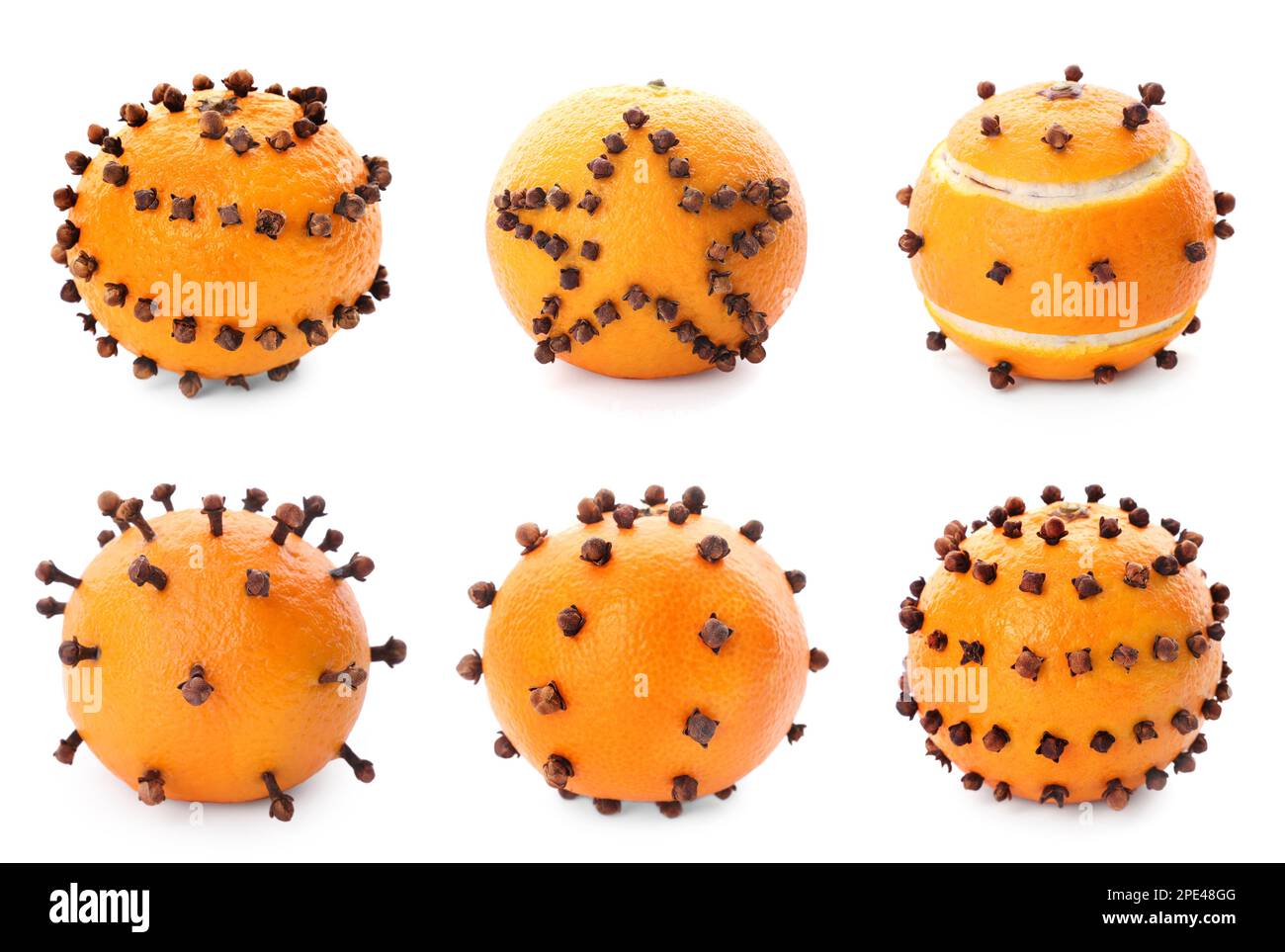 Set with pomander balls made of tangerine and cloves on white ...