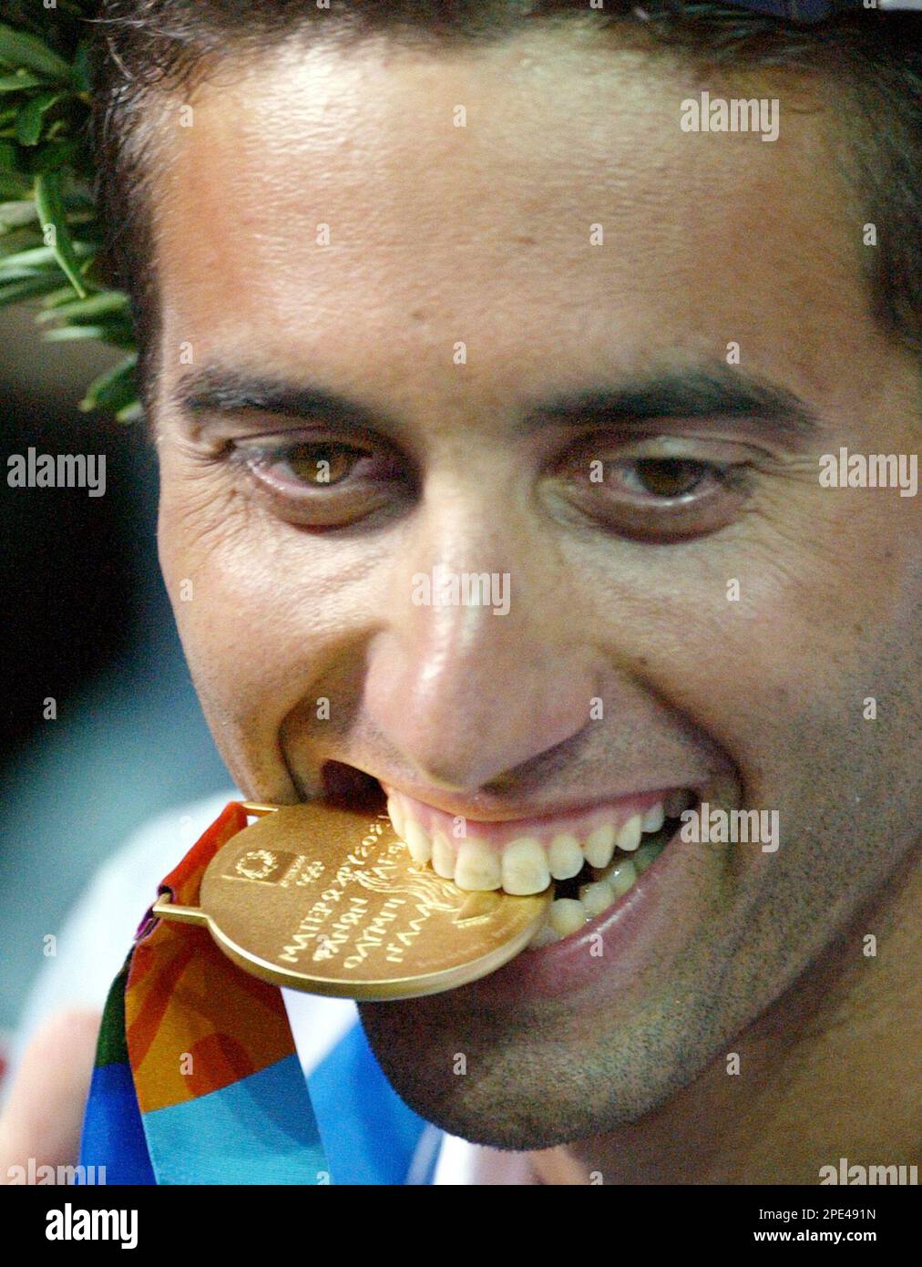 ** FILE ** Israel's Gal Fridman bites his gold medal after winning the ...