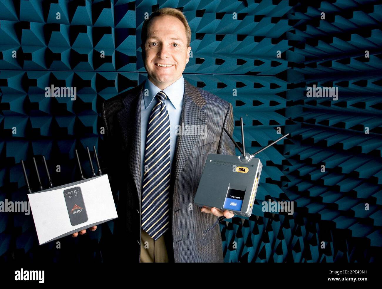 Greg Raleigh, founder of Airgo Networks, holds two wireless routers in ...