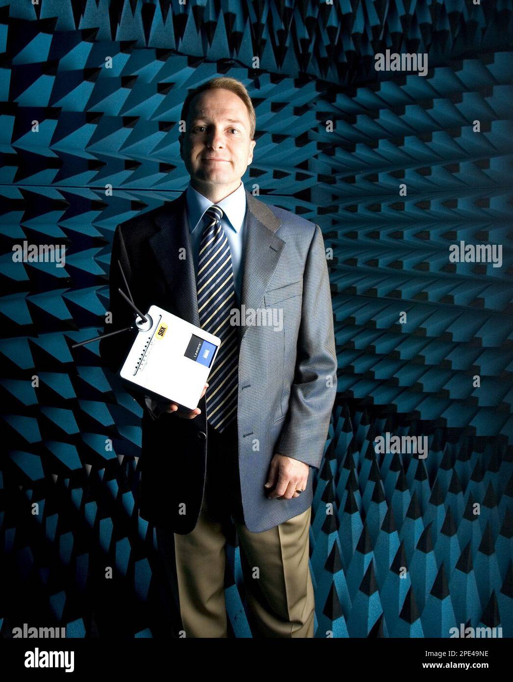 Greg Raleigh, founder of Airgo Networks, holds two wireless routers in ...