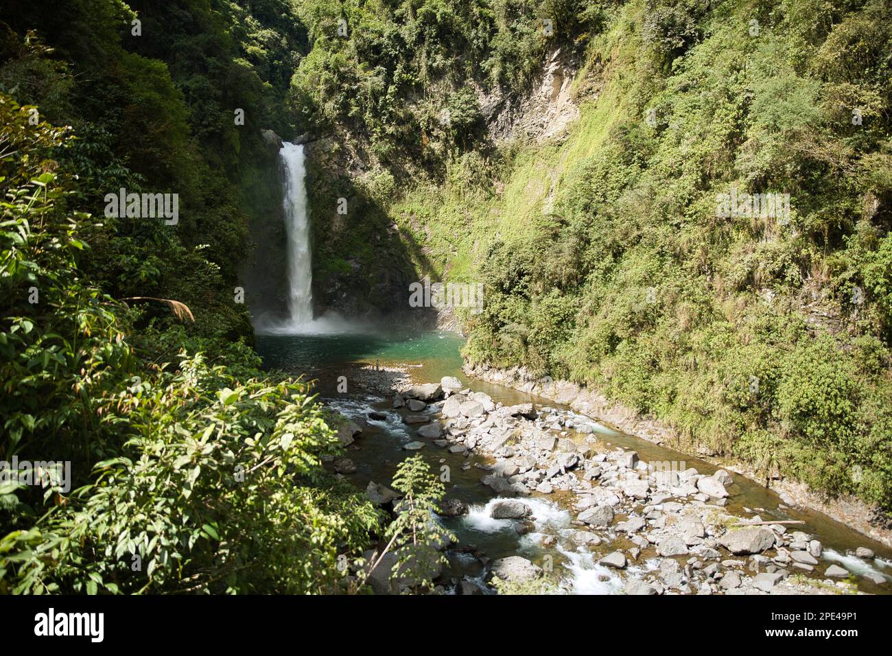 An imposing waterfall in an enclosed valley in Banaue in the ...