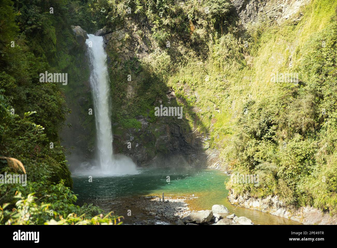 An imposing waterfall in an enclosed valley in Banaue in the ...