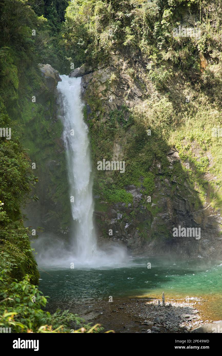 An imposing waterfall in an enclosed valley in Banaue in the ...
