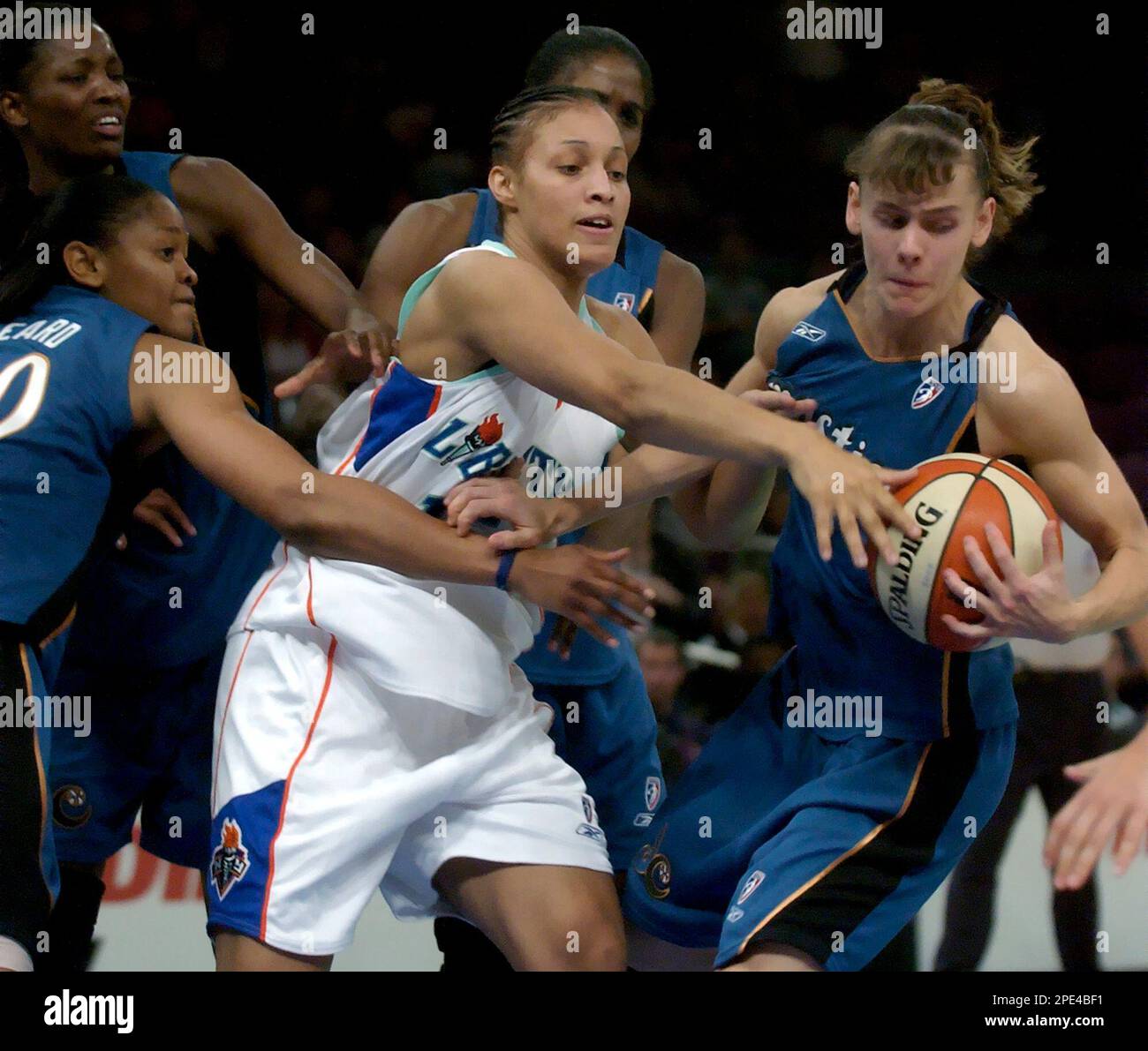 Washington Mystics' Coco Miller, right, pulls down a rebound away from ...