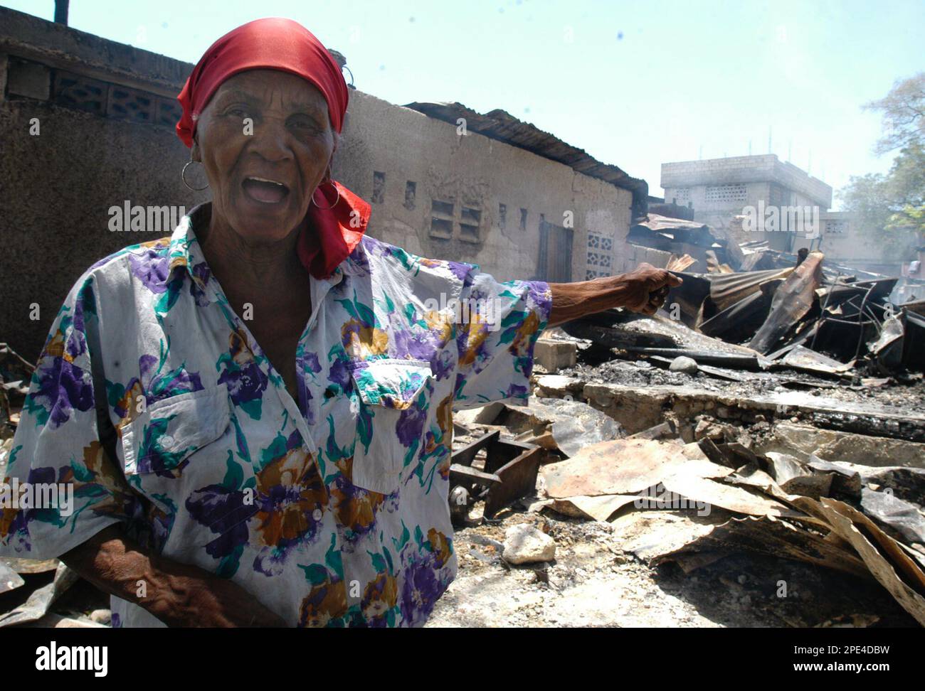 Claire Eloge, 60, points to her smoldering house she blamed on the ...