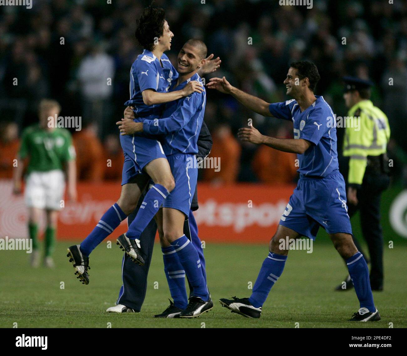 Israel captain Avi Mimny, centre, celebrates with Yossi Benyoun, left ...