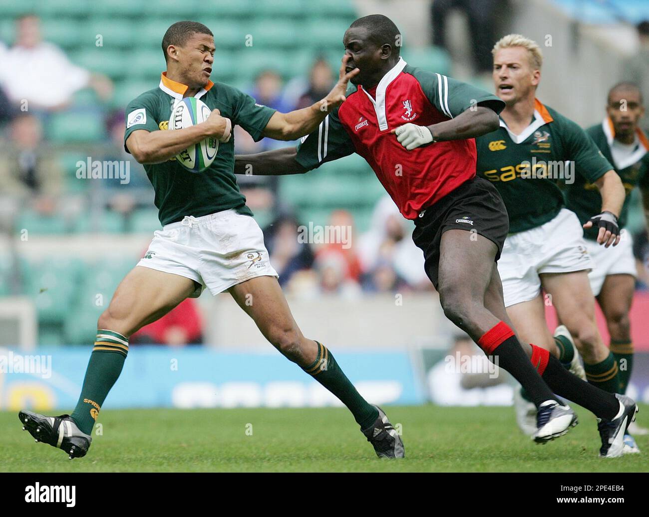 South Africa's Stefan Besson, left, holds off Kenya's Teddy Omondl ...