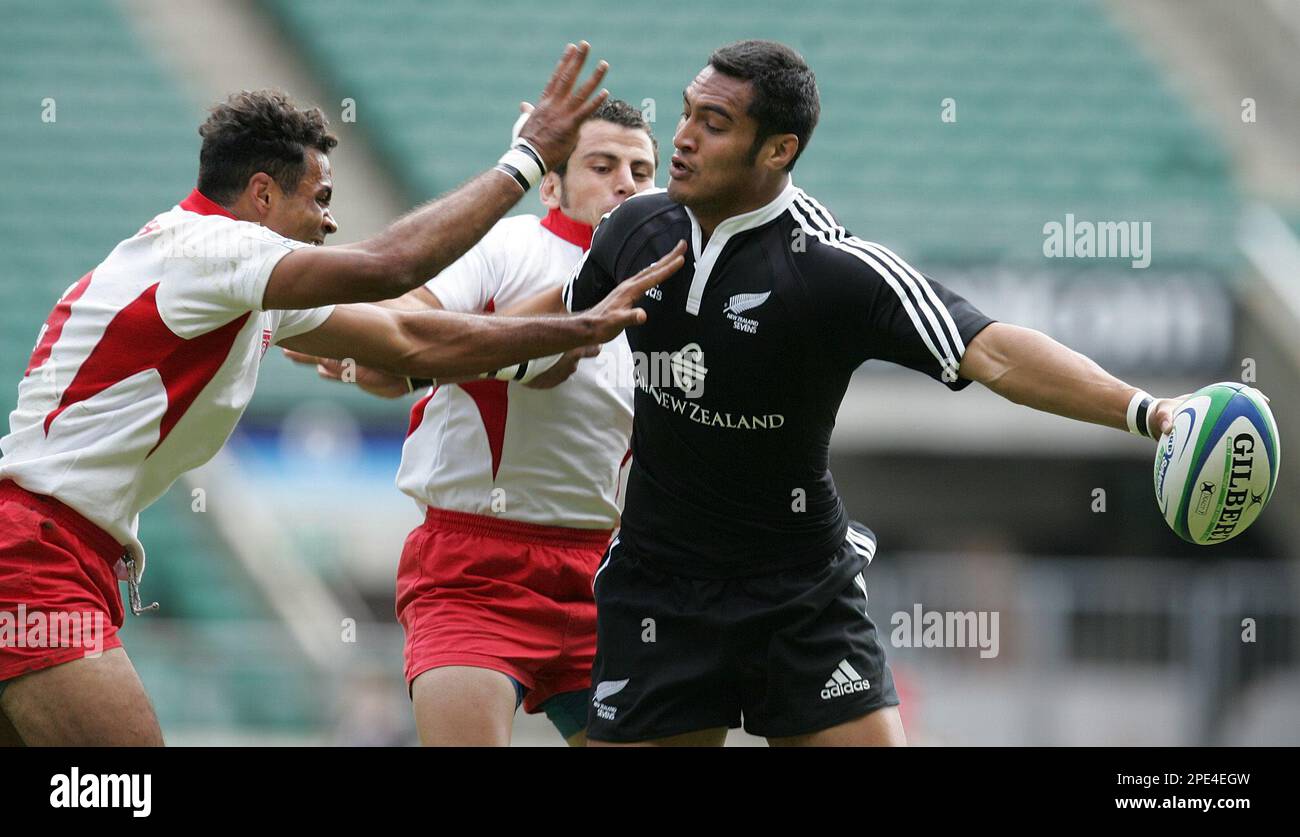 New Zealand's Gerorge Naoupu, right, is tackled by Tunisia's Lotfi Nino ...