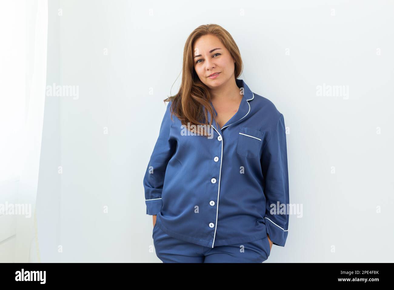 Glamorous woman wears pajama with happy smile chilling in good morning ...