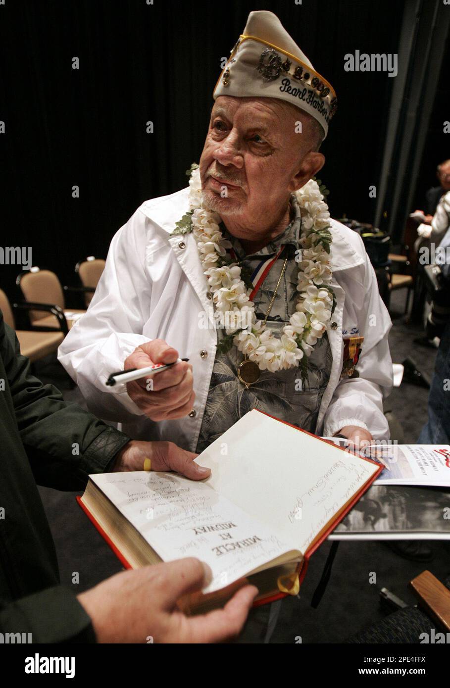 Retired Chief Howard Snell, of Tyler, Texas., autographs a book about ...