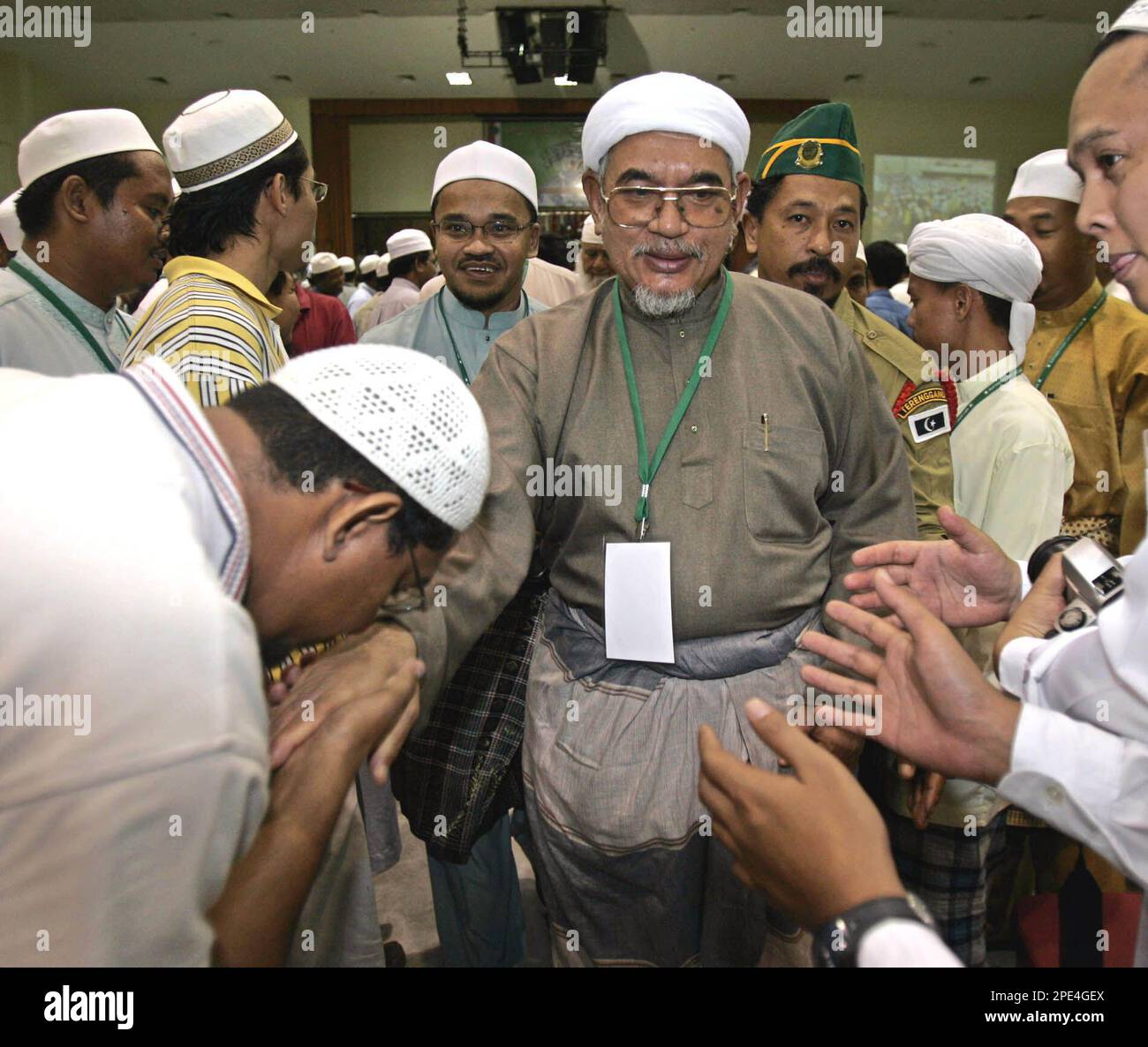 Pan-Malaysian Islamic Party (PAS) President Abdul Hadi Awang, center ...