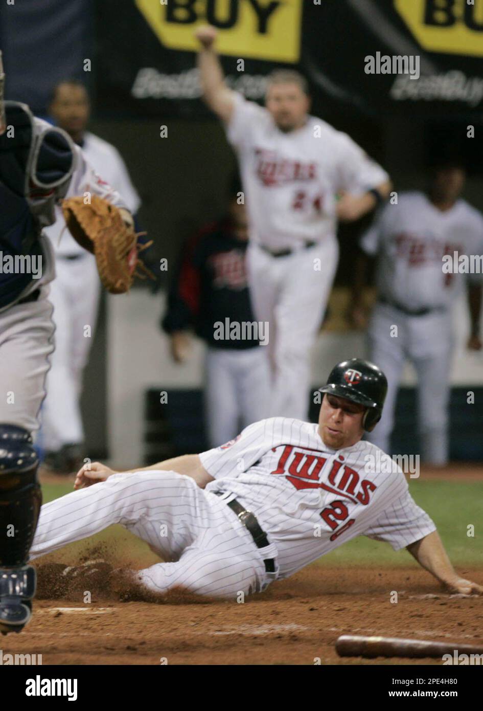 Minnesota Twins' Matthew LeCroy, background, celebrates as Lew Ford ...