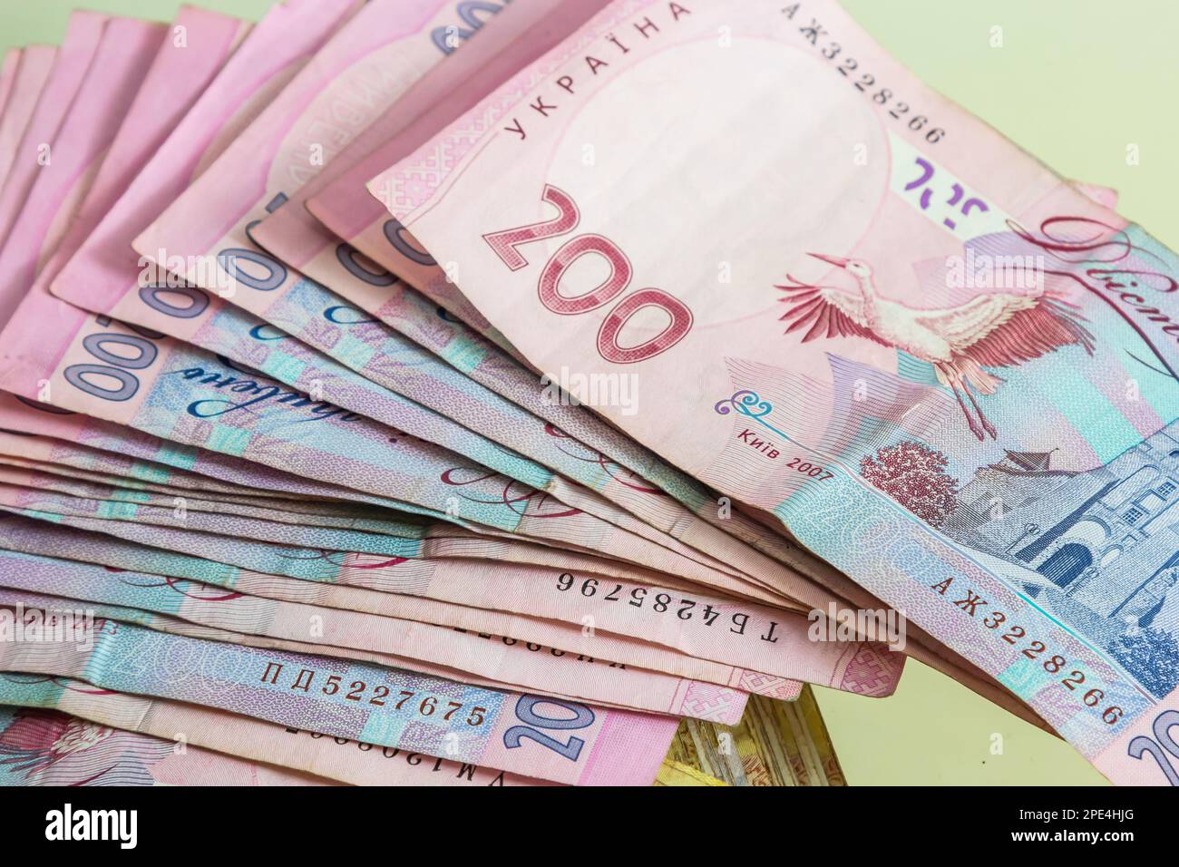 Ukrainian paper money is laid out on a blue background. 200 hryvnia ...