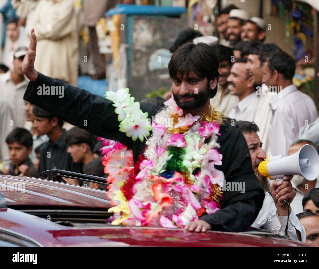 Indian separatist Kashmiri leader Yasin Malik waves to his supporters ...