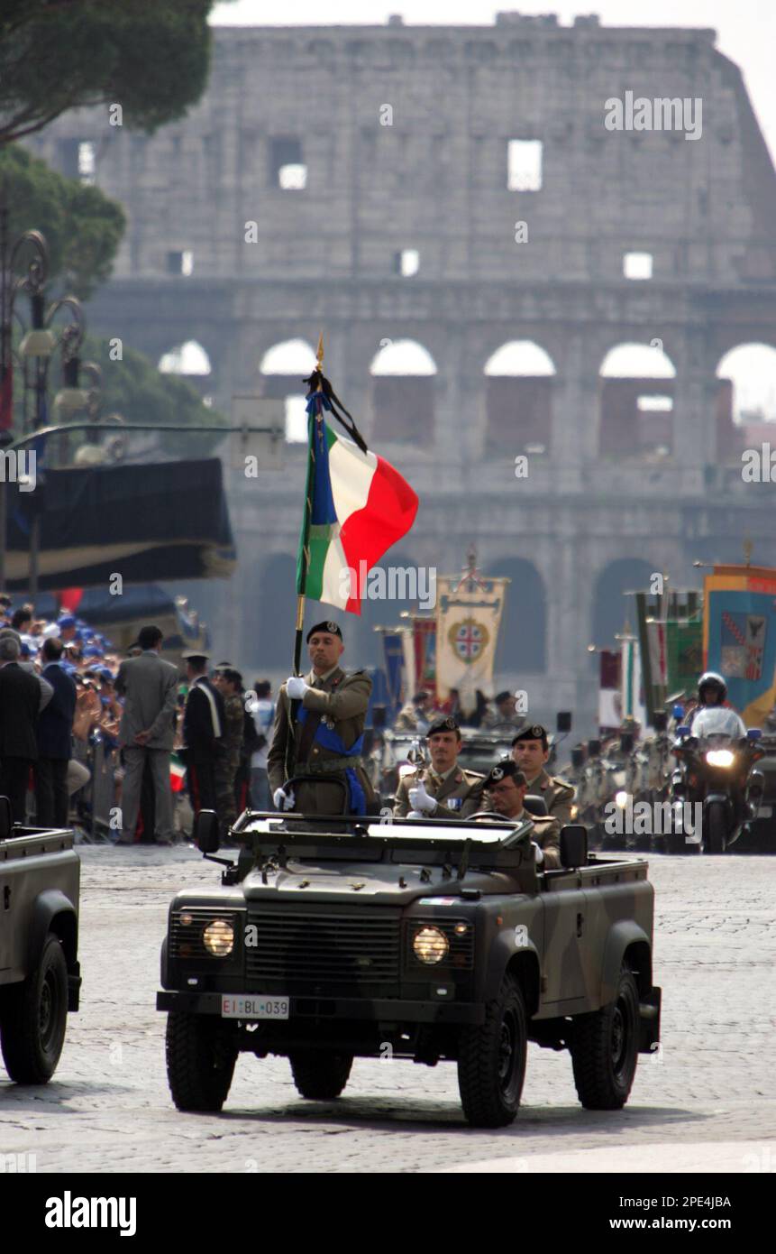 With the Colosseum in background, the flag of the Italian Army parades ...