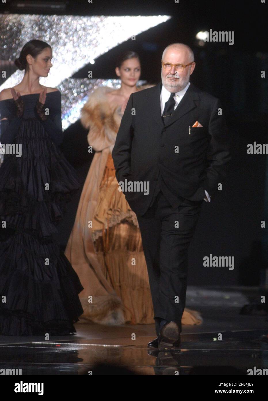 Italian designer Gianfranco Ferre' makes his way down the catwalk after ...