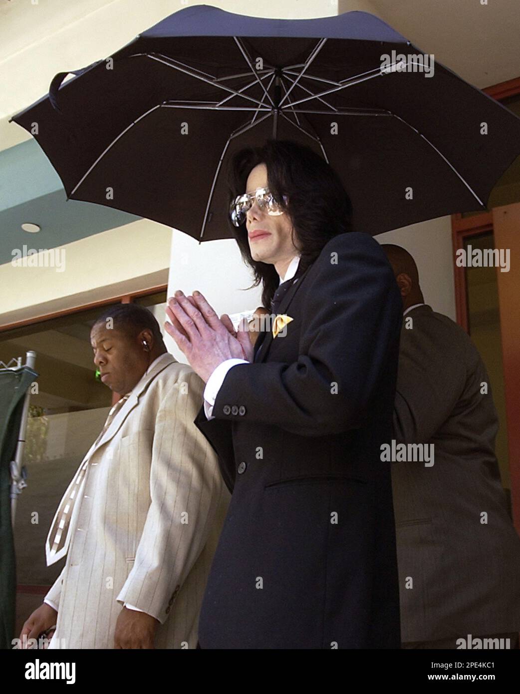Michael Jackson, center, is accompanied by unidentified security guards ...