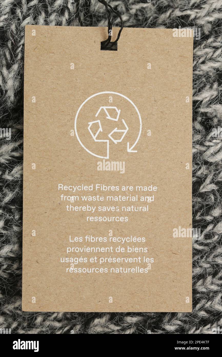 Close up of clothing tag with recycle icon. Recycling products concept ...