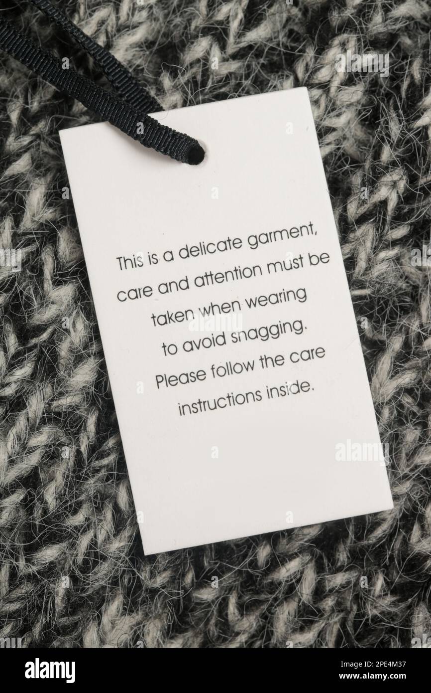 Close up of luxury clothing hang tag. Delicate garment swing tag ...