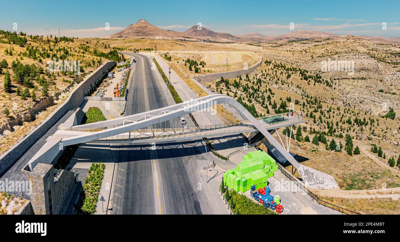 Aerial view of a pedestrian bridge for safe crossing of a fast and busy ...