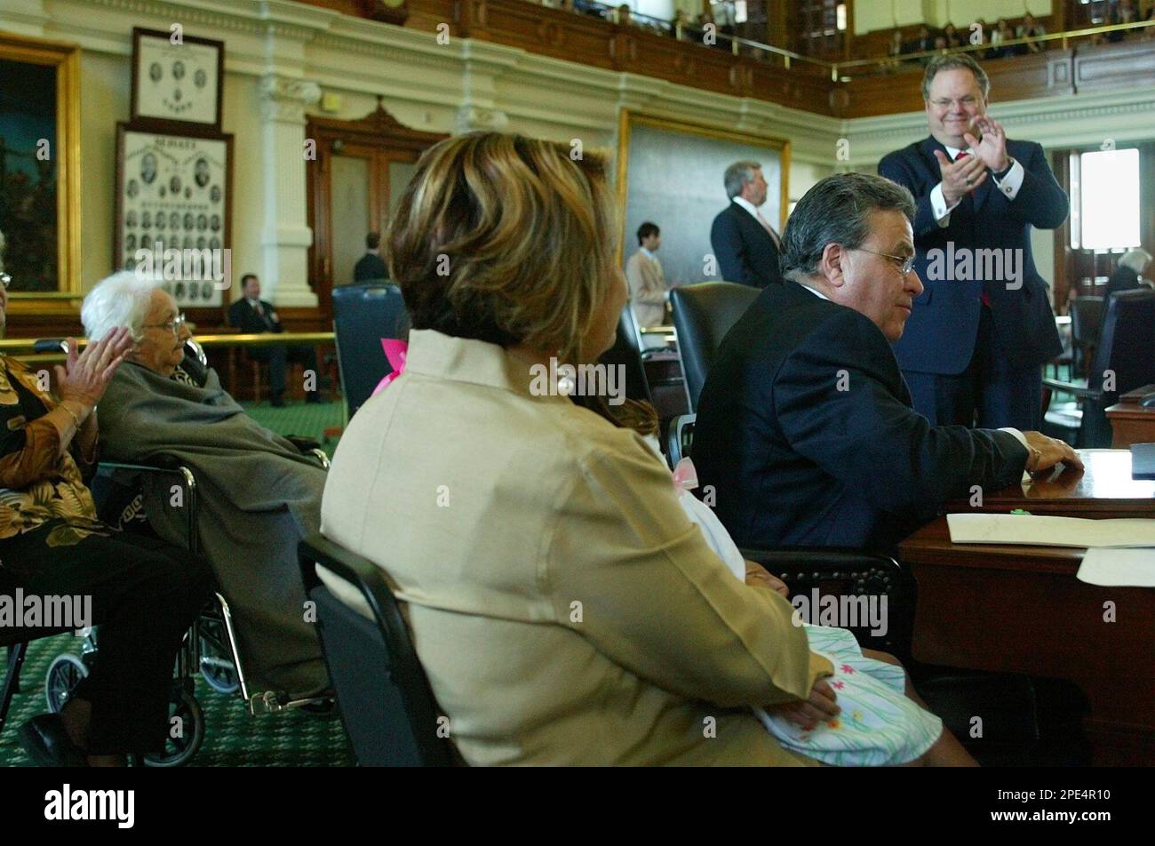 Sen. Frank Madla, D-San Antonio, seated on the right, receives applause ...