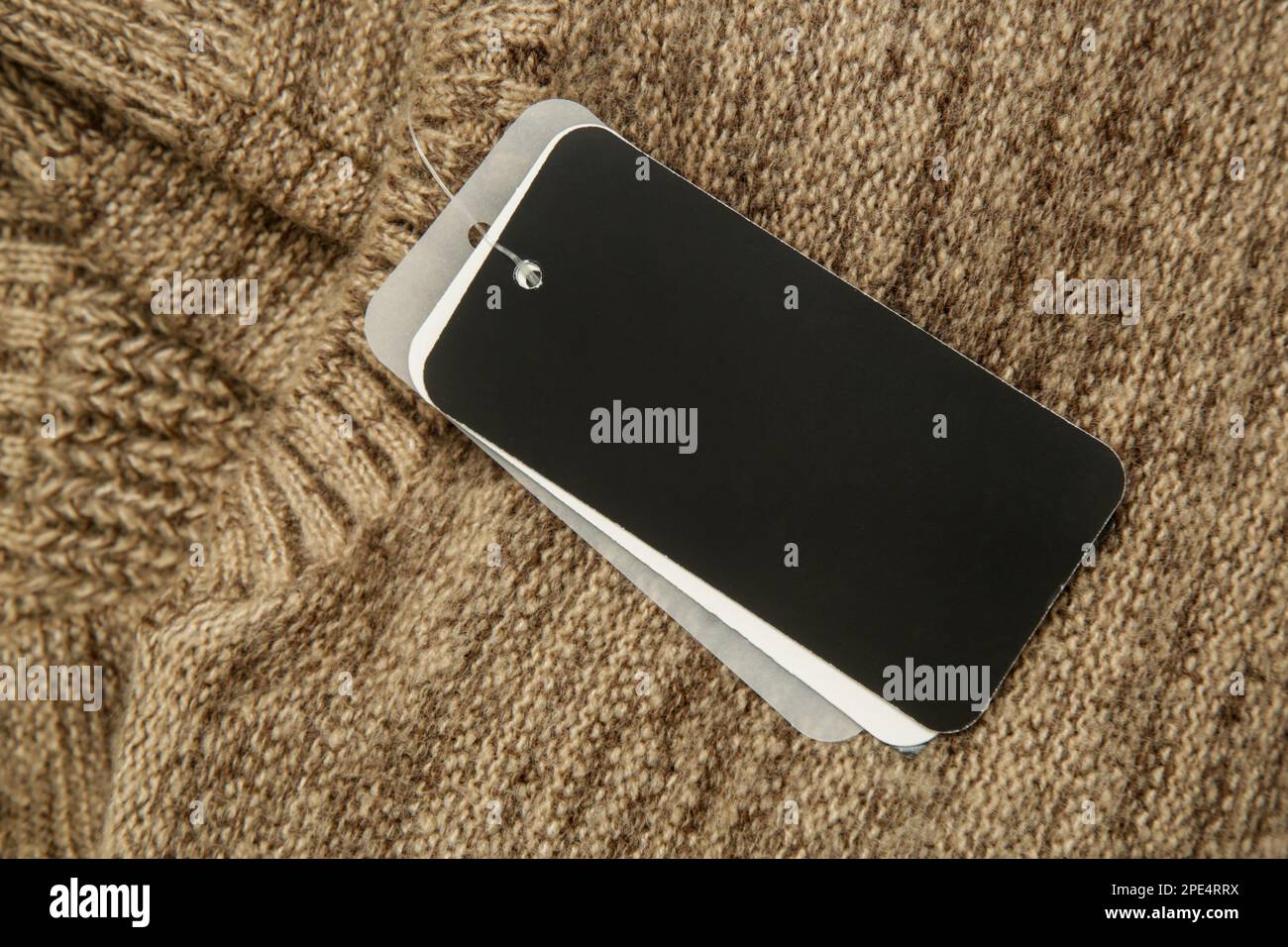 Close up of price tag of clothing item. Blank label tag mockup on a ...