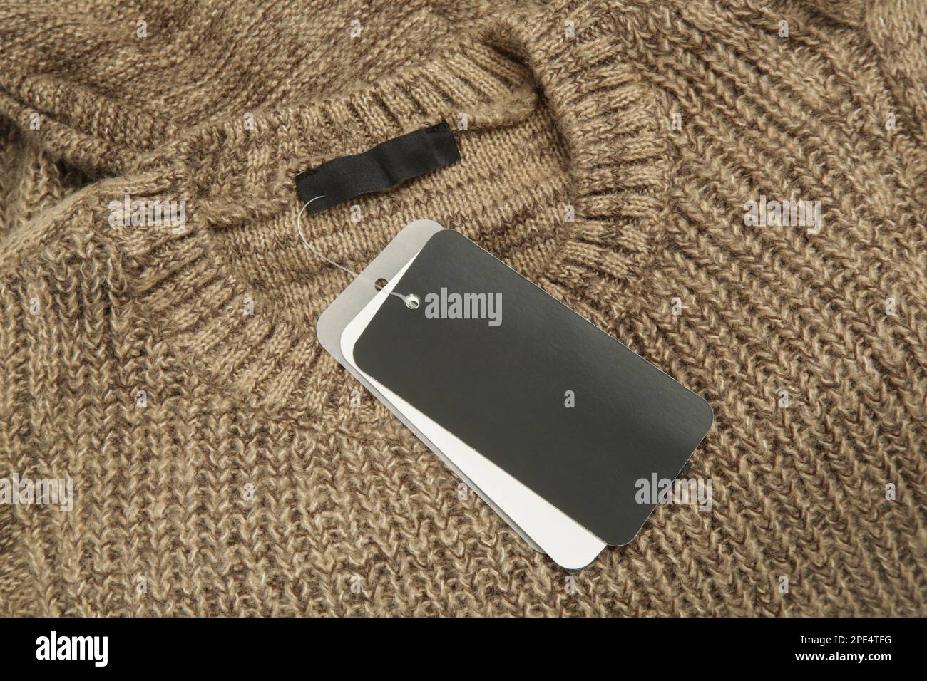 Close up of price tag of clothing item. Blank label tag mockup on a ...