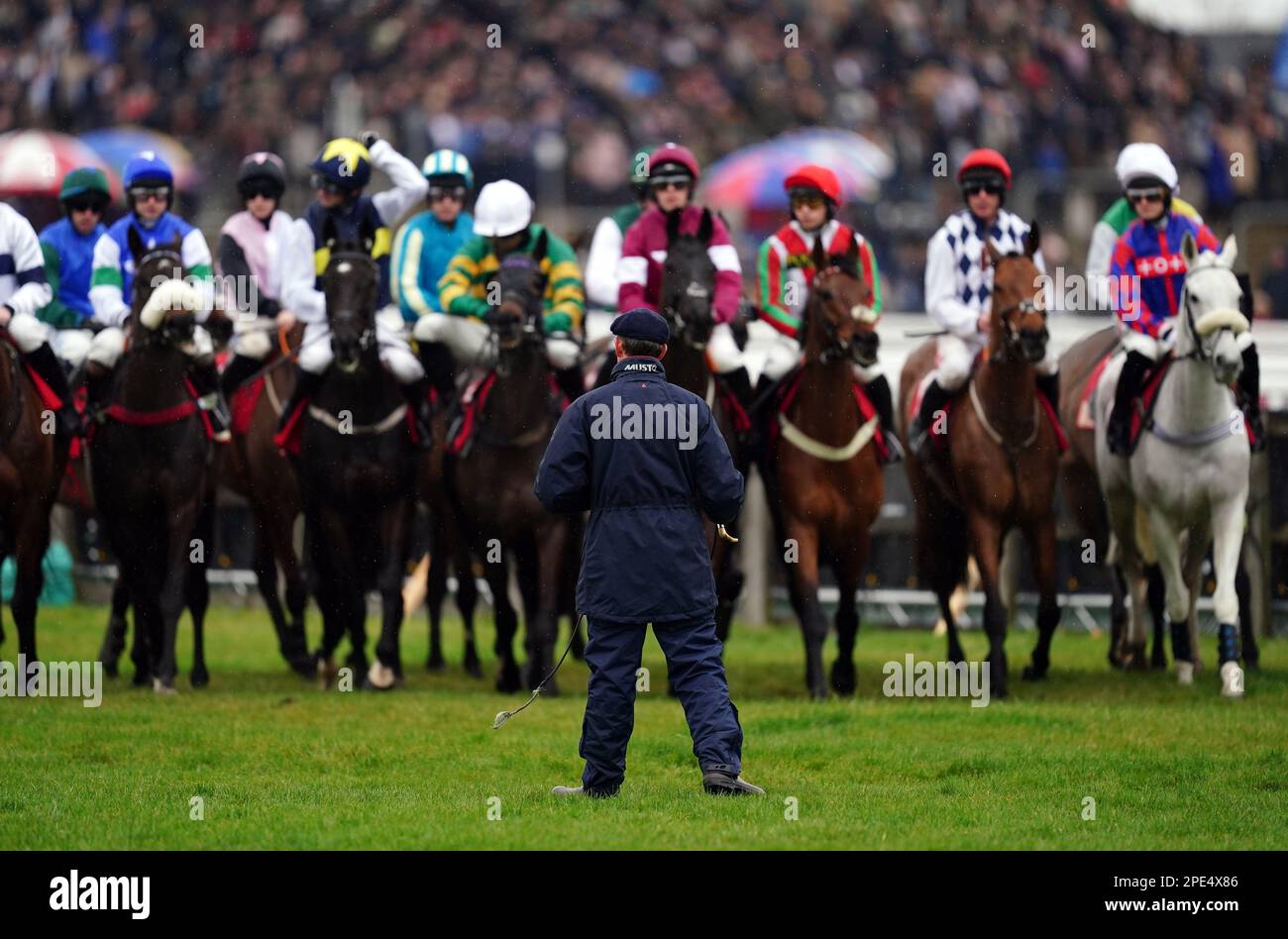 Runners and riders wait behind the starter for the Glenfarclas Chase on ...