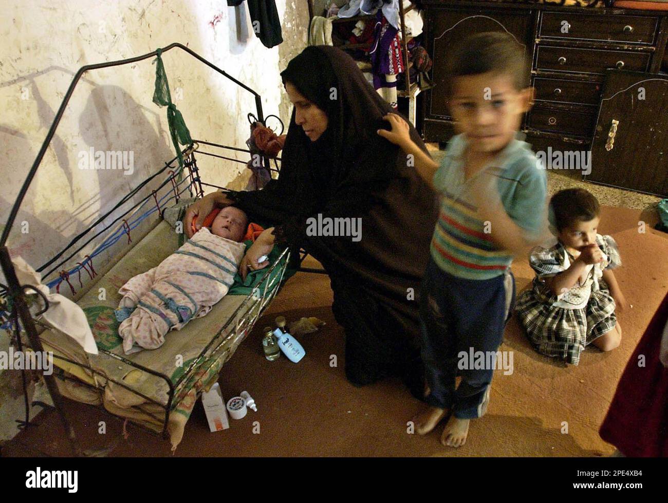 Iranian Ghasimeh Ayashi, 30, cares for her 8 month-old baby Husein as ...