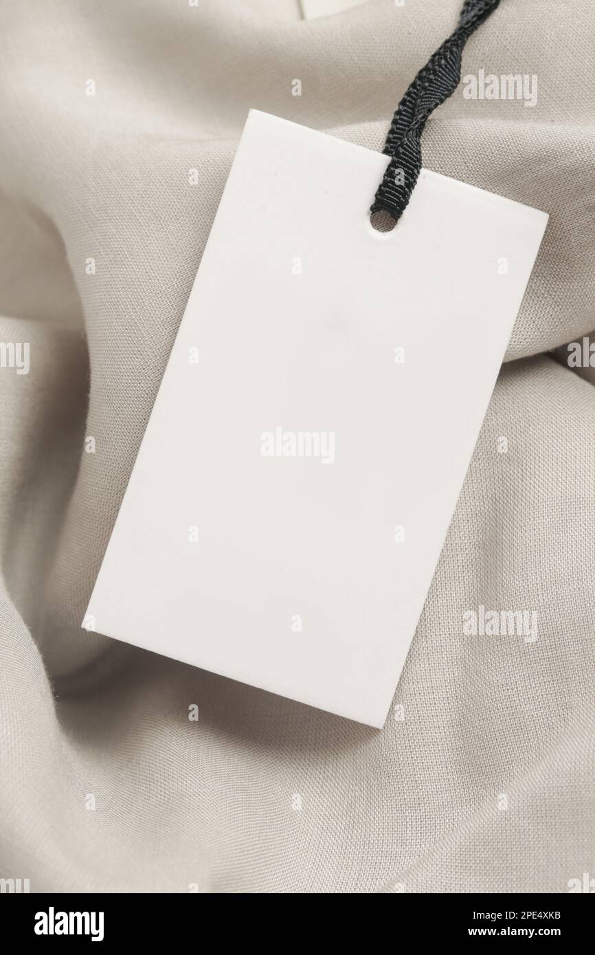 Close up of price tag of clothing item. Blank label tag mockup on a ...