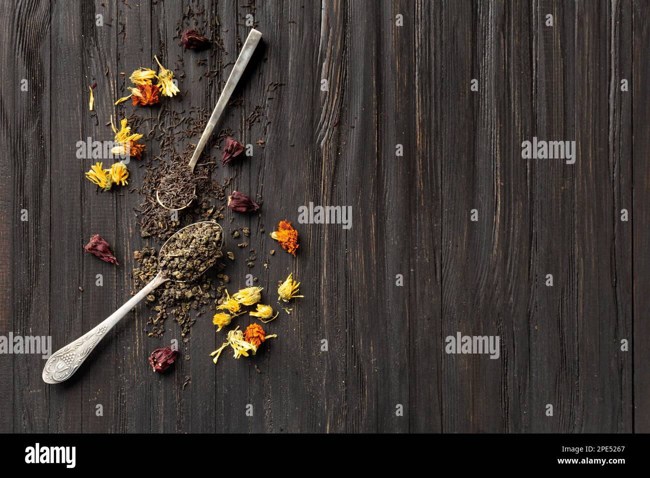 Composition of dry black and green tea in vintage spoons and dry ...