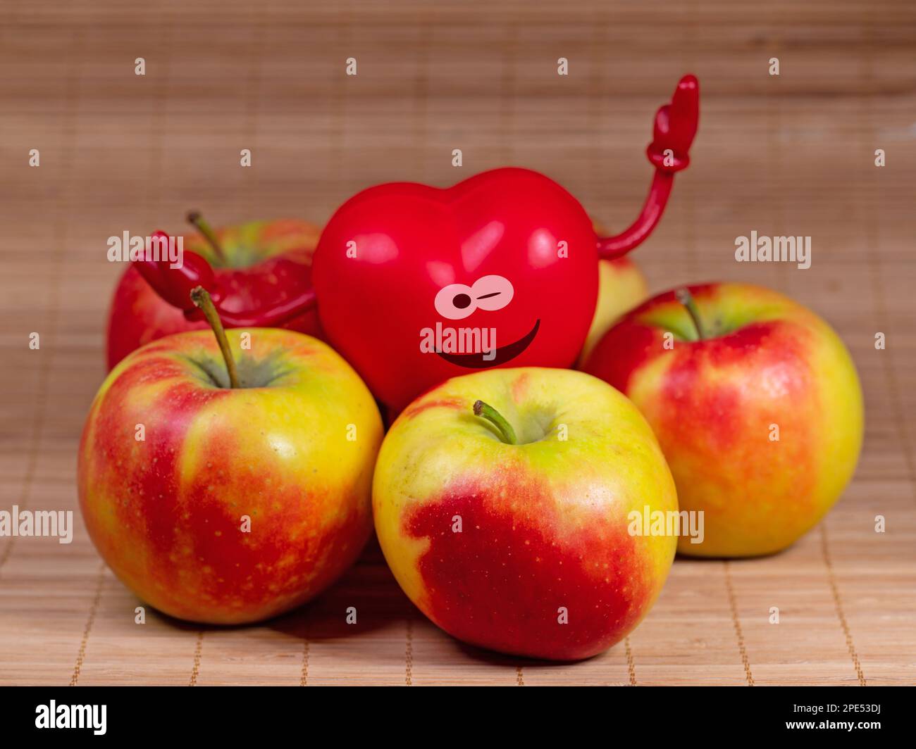 Apples and heart with a smiling face Stock Photo - Alamy