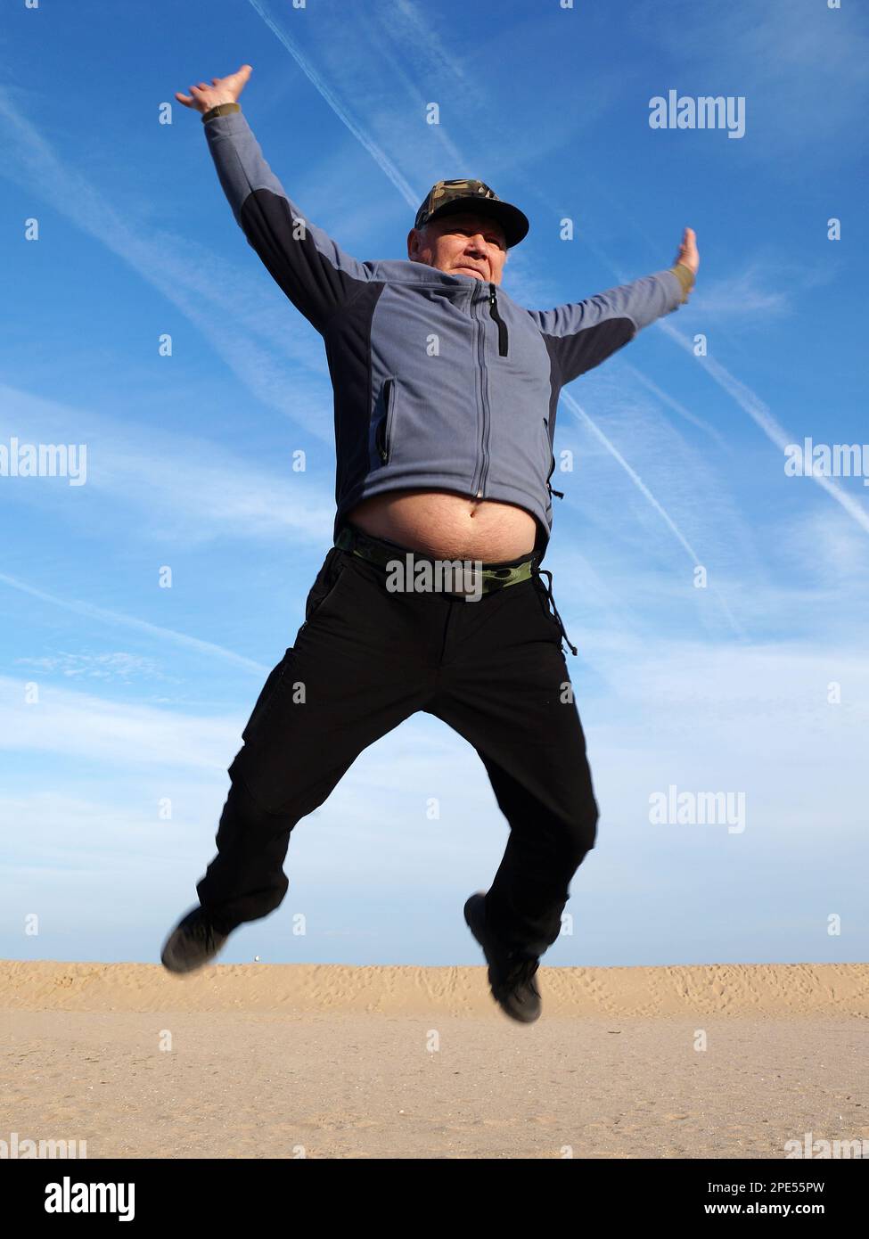 Young man jumping against blue sky hi-res stock photography and images ...