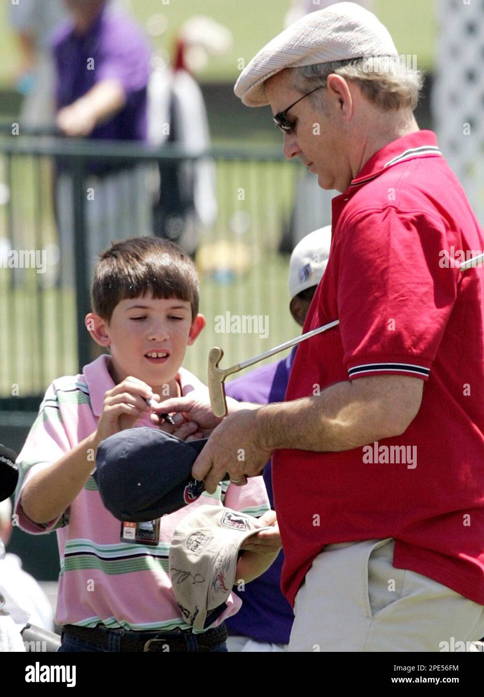 Entertainer Bill Murray, right, signs an autograph for a young fan ...