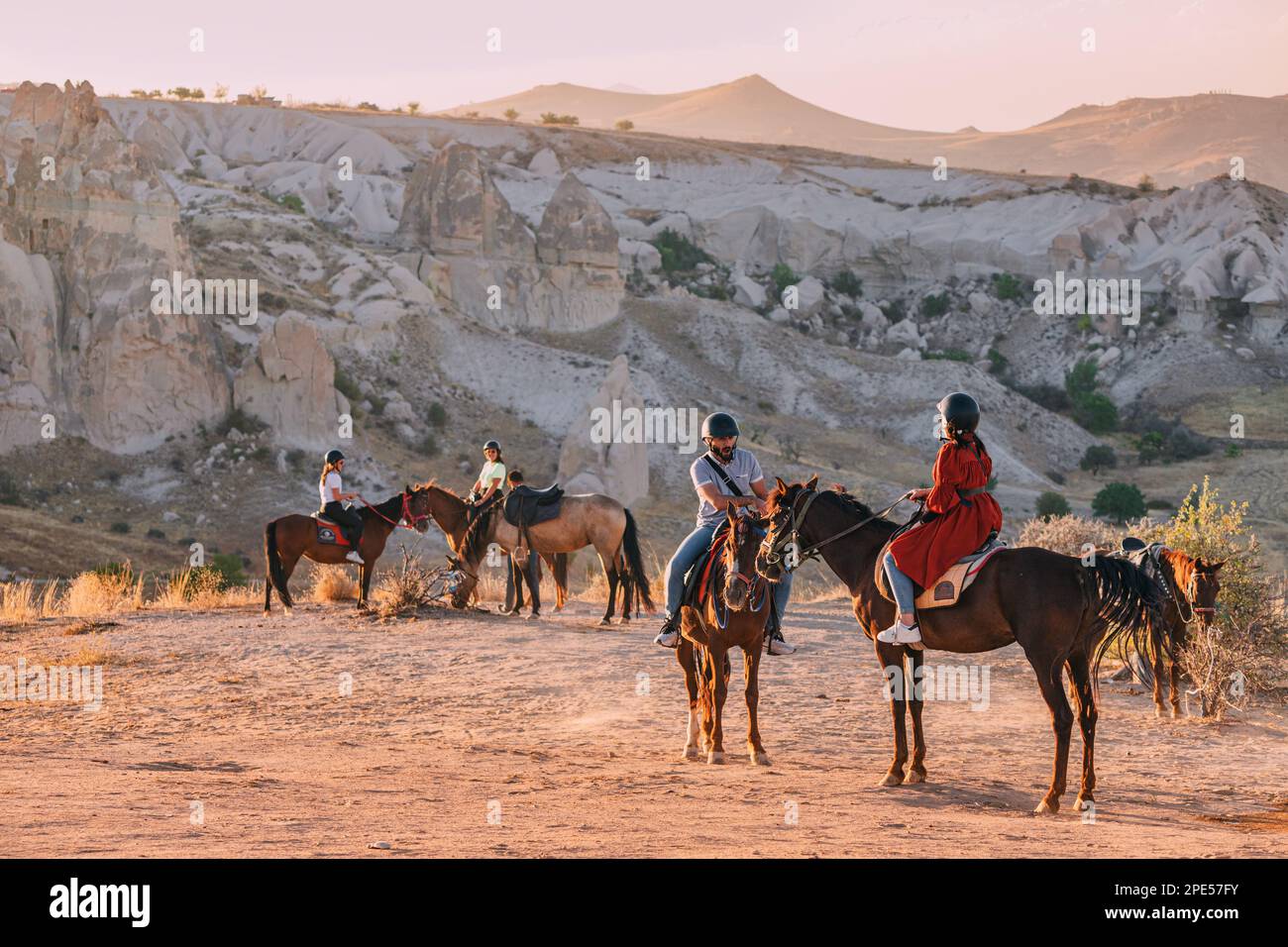 12 September 2022, Cappadocia, Turkey: Group of tourists riding horses ...