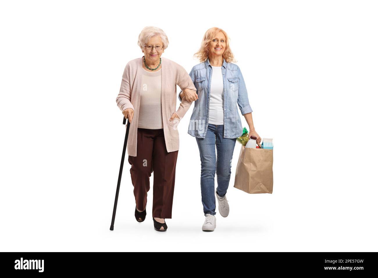 Full length portrait of a woman helping an elderly lady and carrying ...