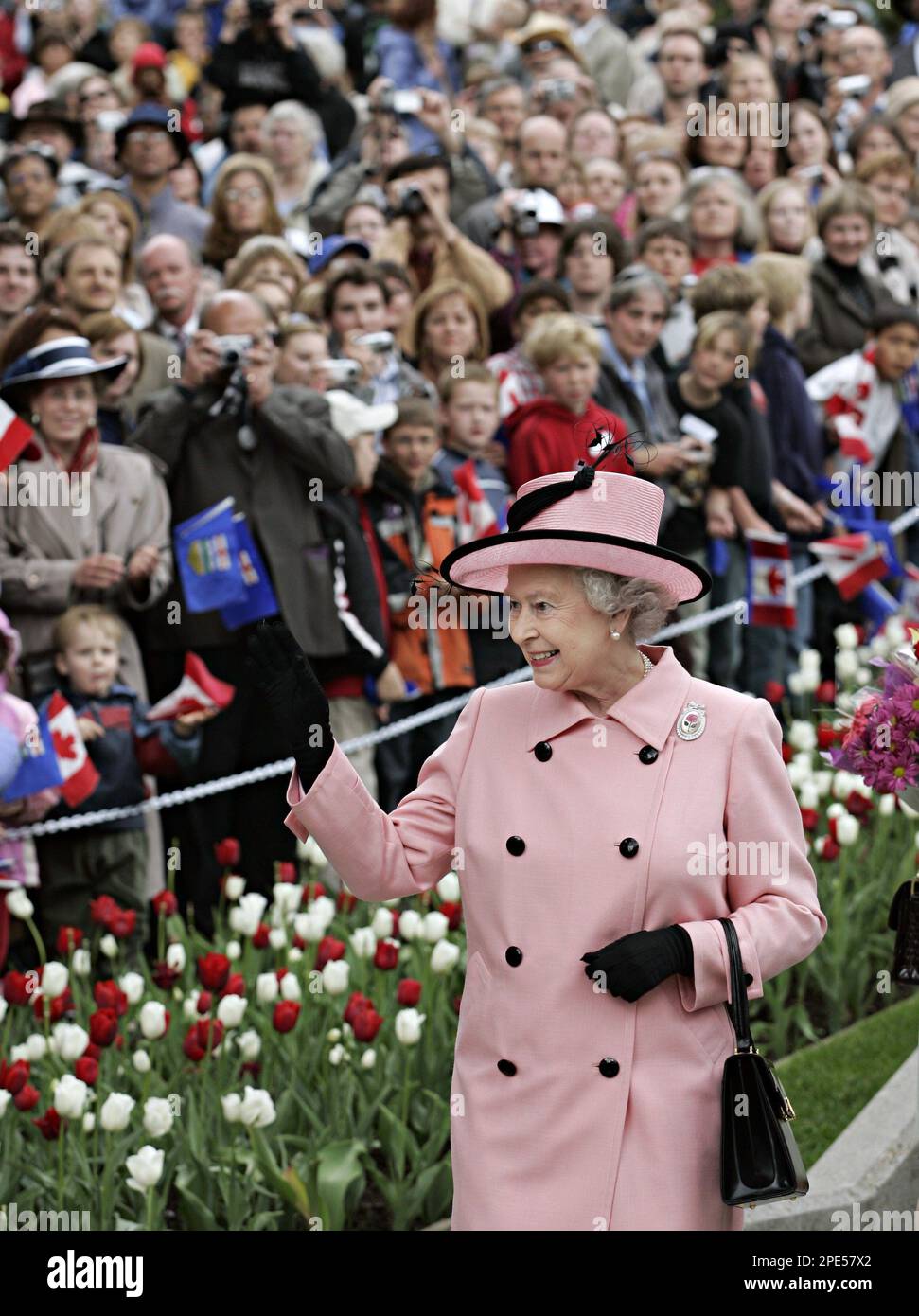 Queen Elizabeth II waves to the crowd as she leaves the Alberta ...