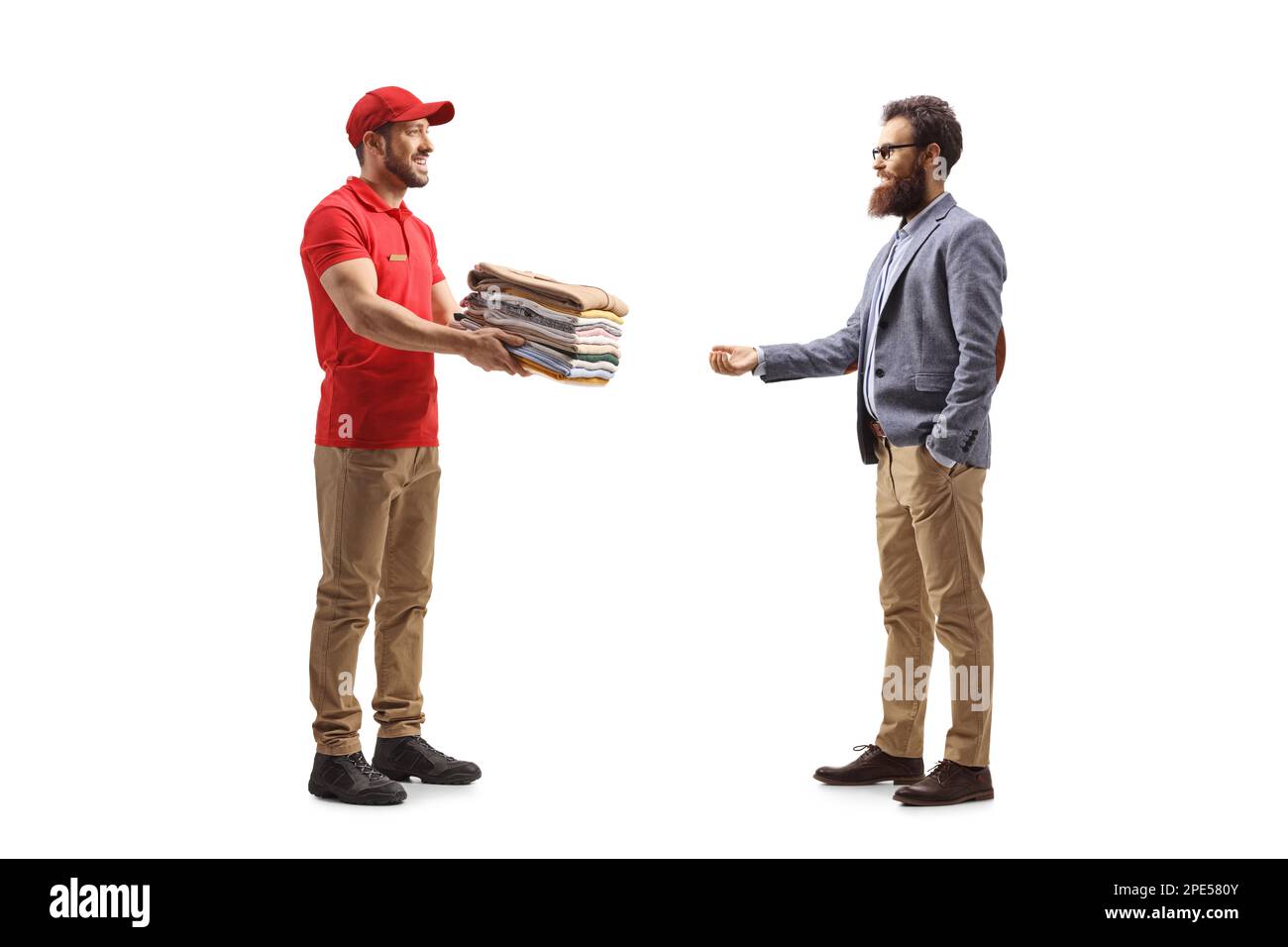 Man delivering pile of dry cleaned clothes to a male customer isolated ...