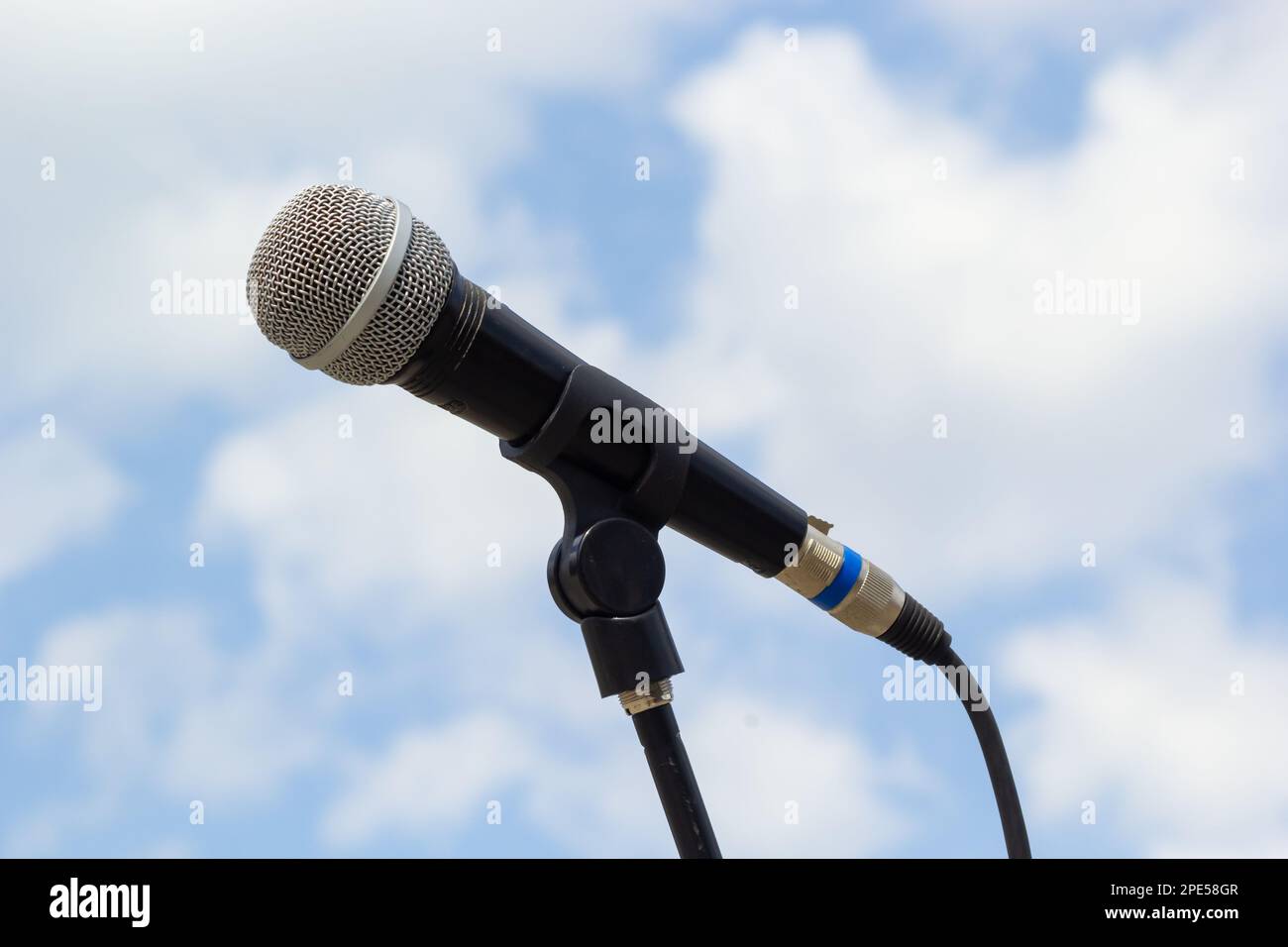 Microphone on sky background. The microphone is on the street. Concept ...