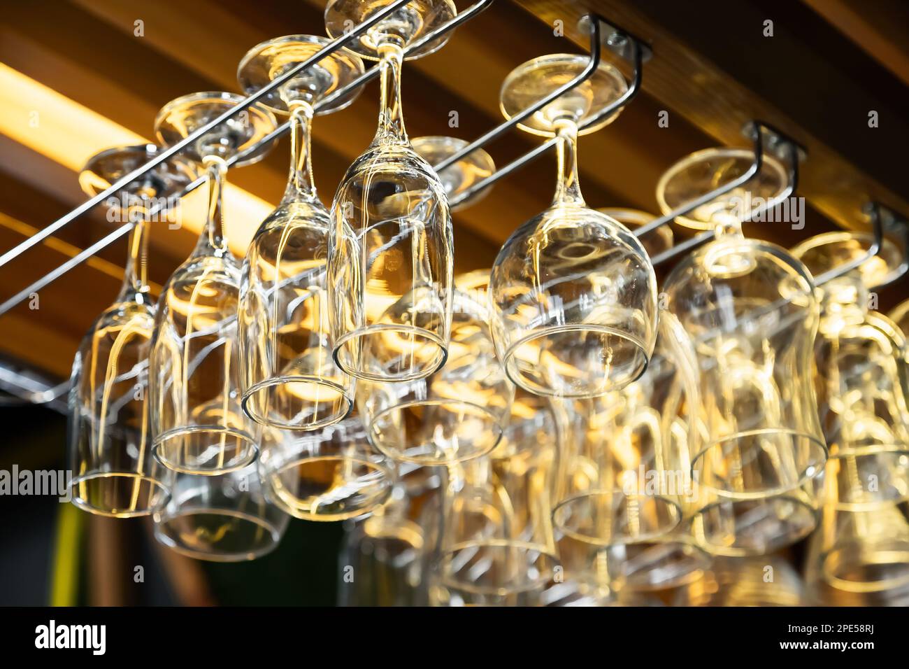 clean wine glasses hang over the bar. Glass, utensils, objects Stock ...