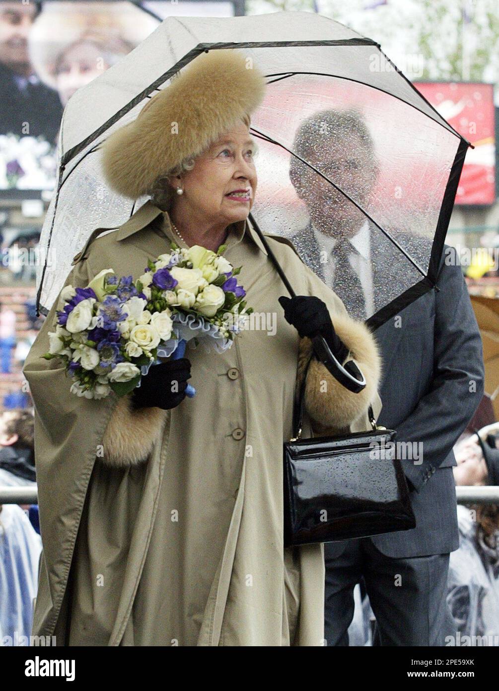 Alberta Premier Ralph Klein follows Queen Elizabeth II onto the seating ...